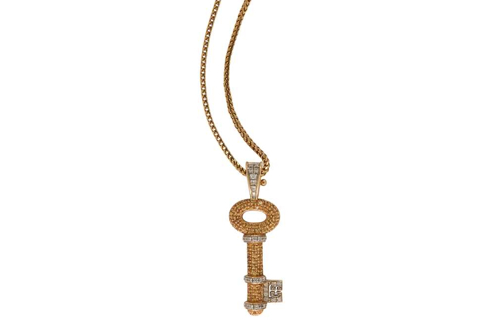 Lot 111 - A diamond and yellow sapphire key pendant