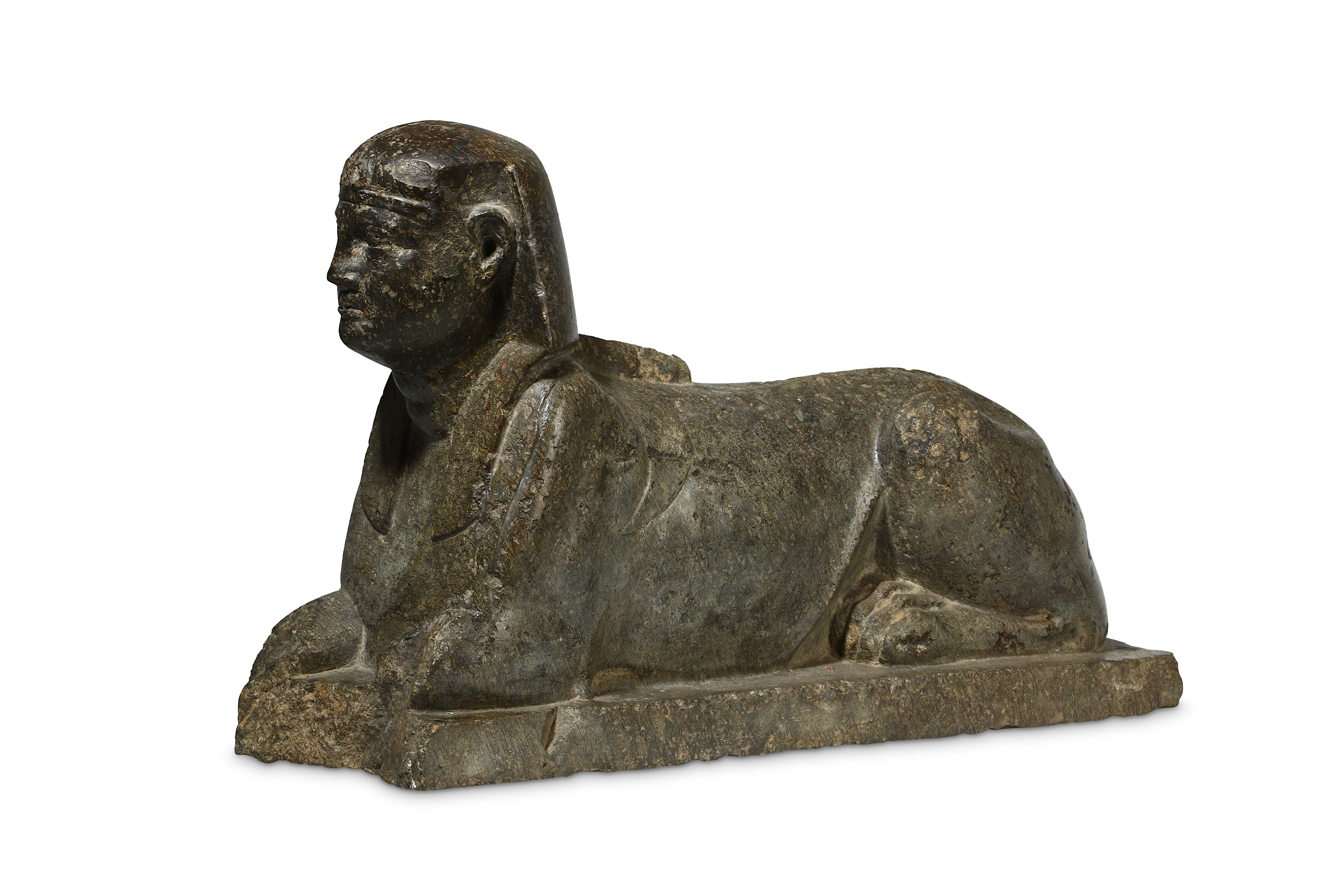 Lot 68 - AN EGYPTIAN SERPENTINE SPHINX Roman Period,