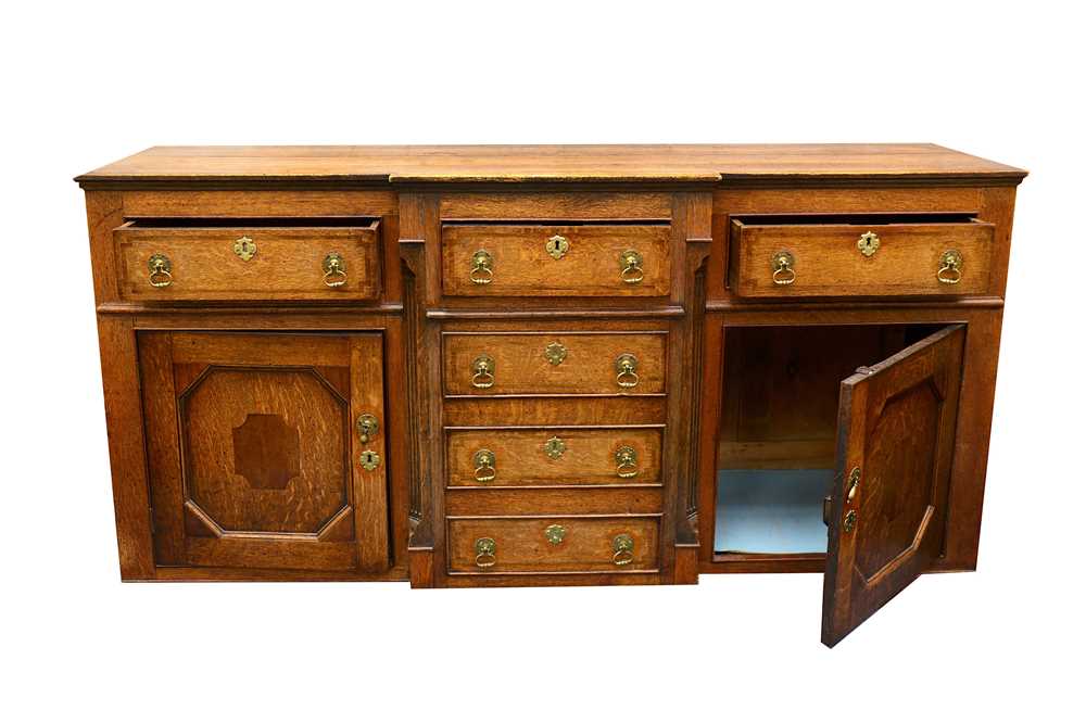 Lot 346 - A George III oak breakfront dresser, with