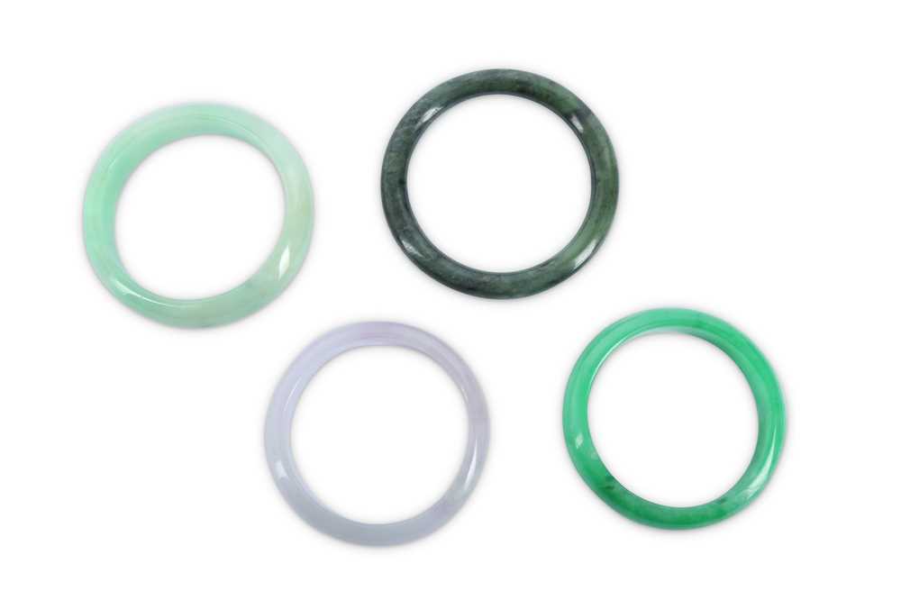 Lot 580 - FOUR CHINESE JADEITE BANGLES.