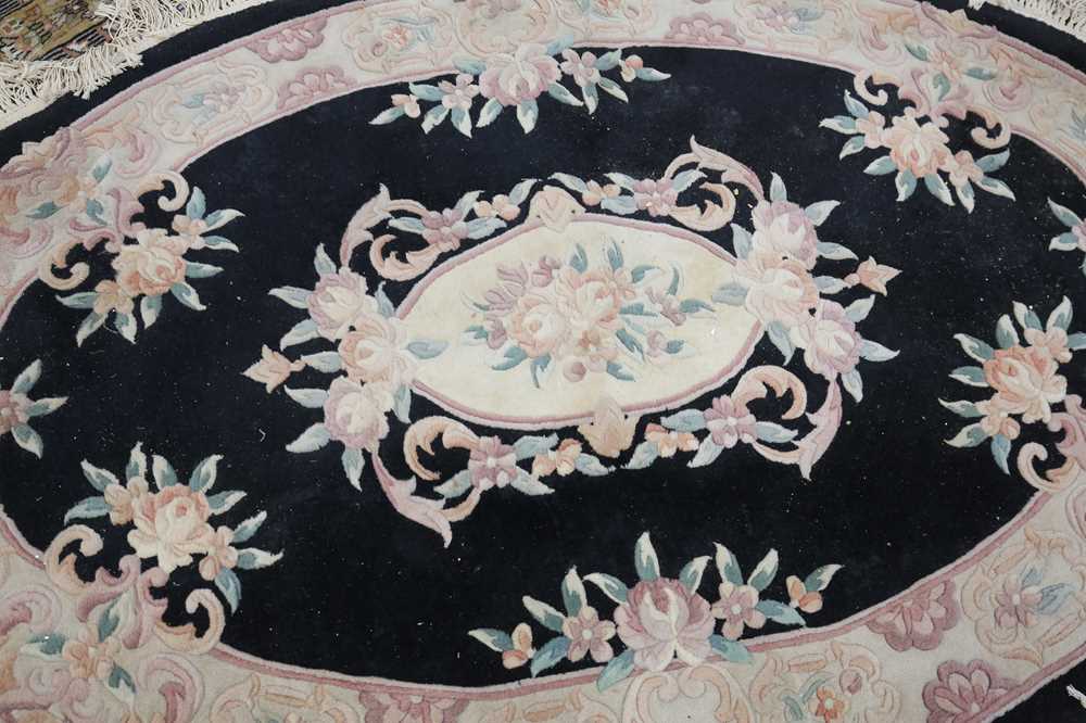Lot 63 - A CHINESE OVAL WOOL RUG, 20TH CENTURY