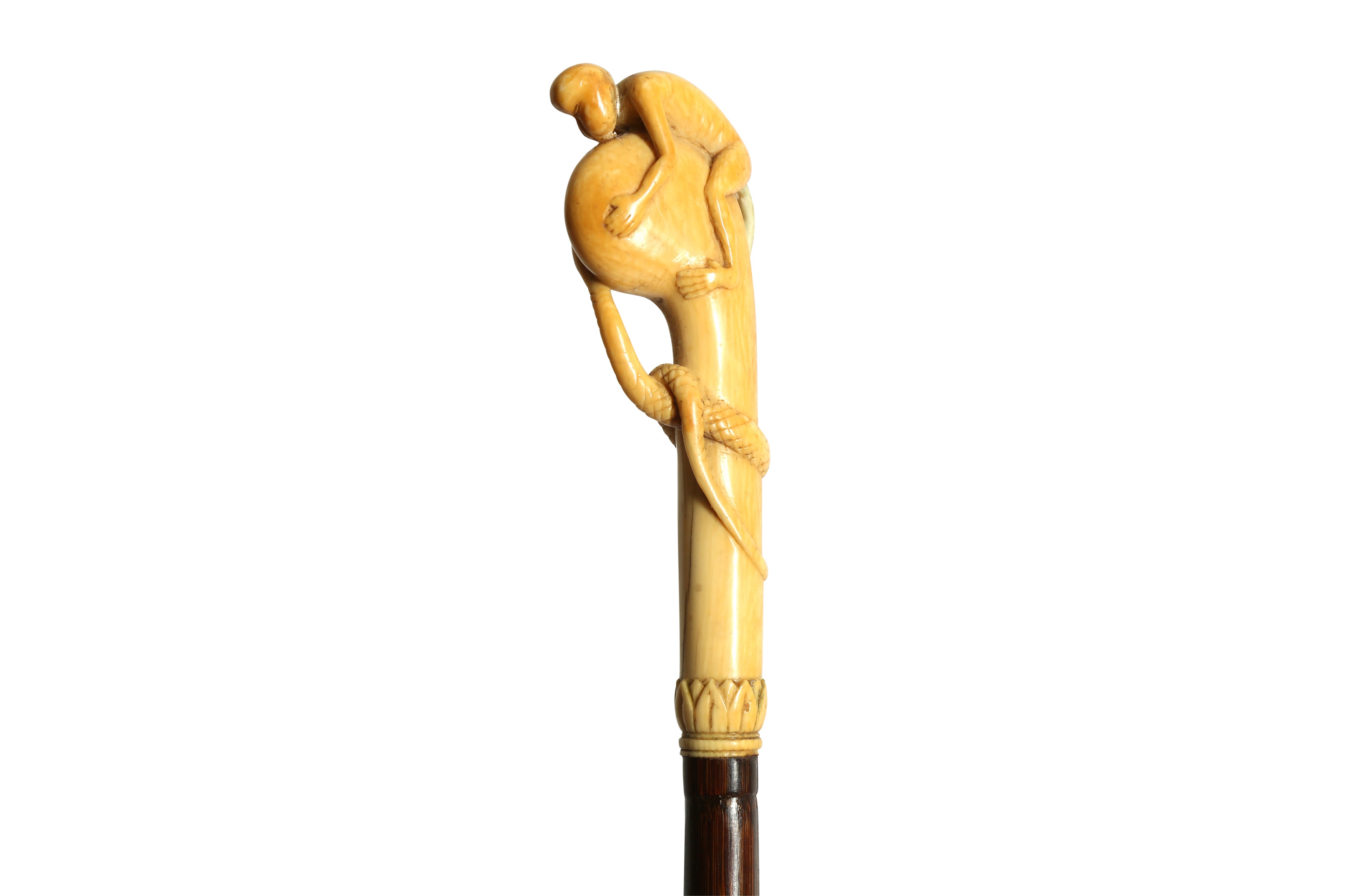Lot 246 - A NAIVE CARVED IVORY HANDLED WALKING CANE,