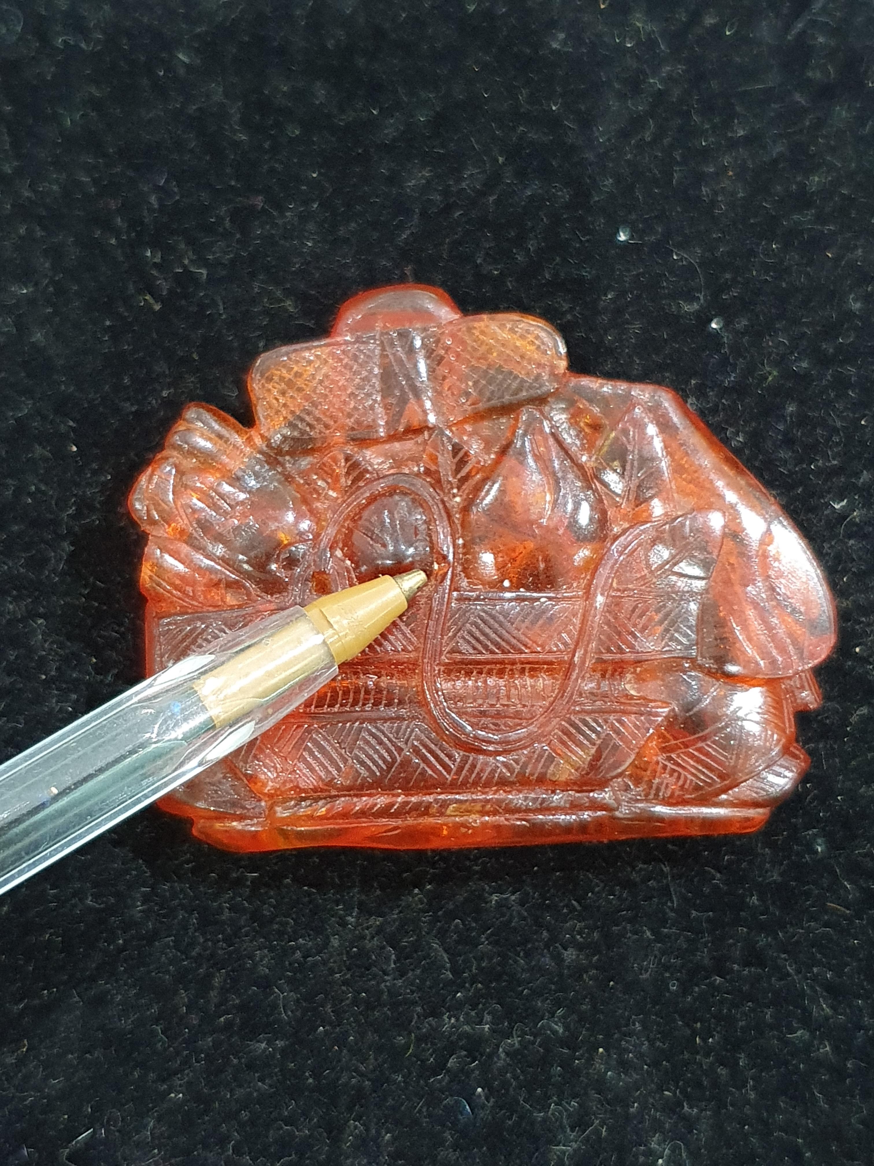Lot 700 - TWO CHINESE AMBER CARVINGS.