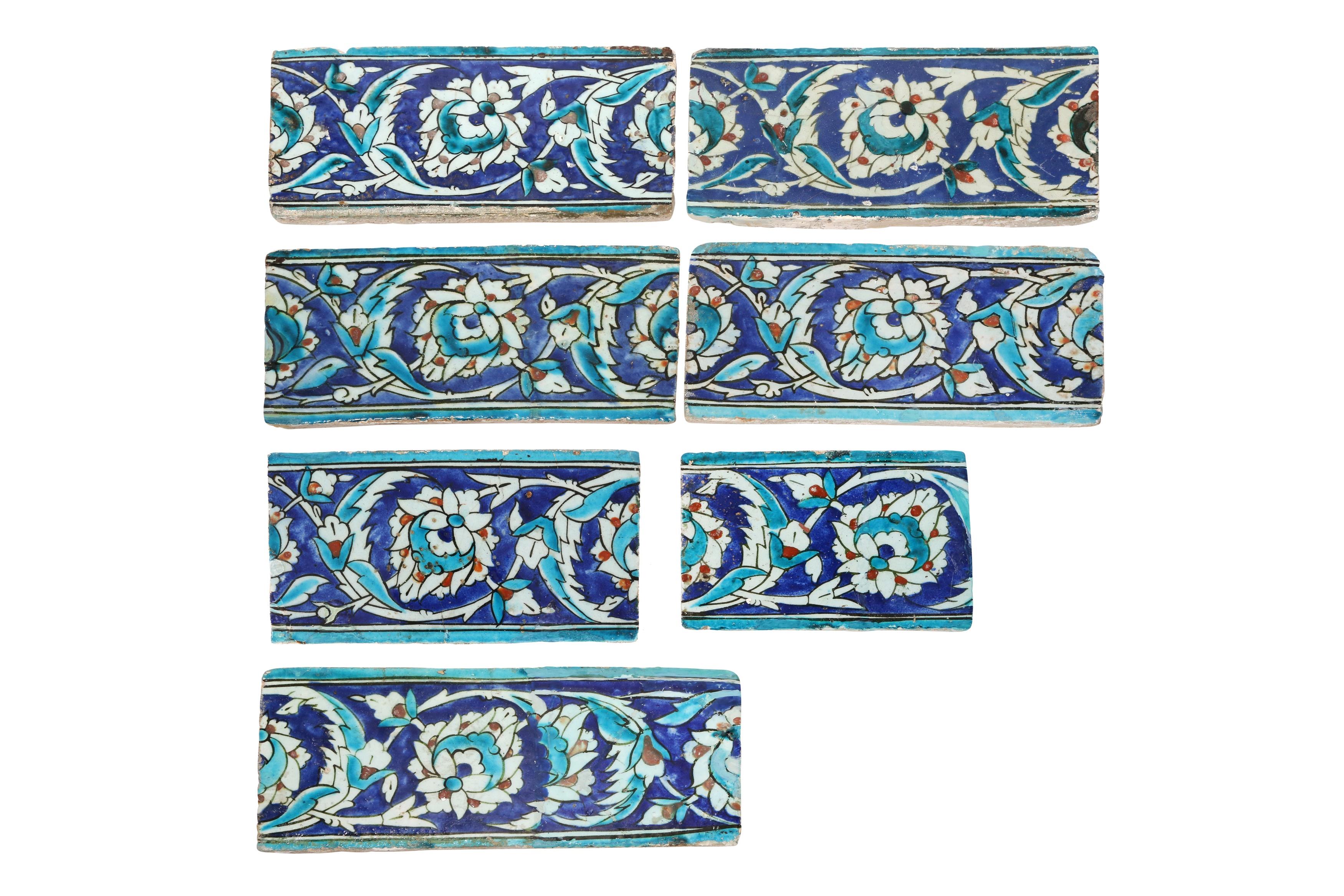 Lot 332 - SEVEN IZNIK POTTERY BORDER TILES WITH LOTUS