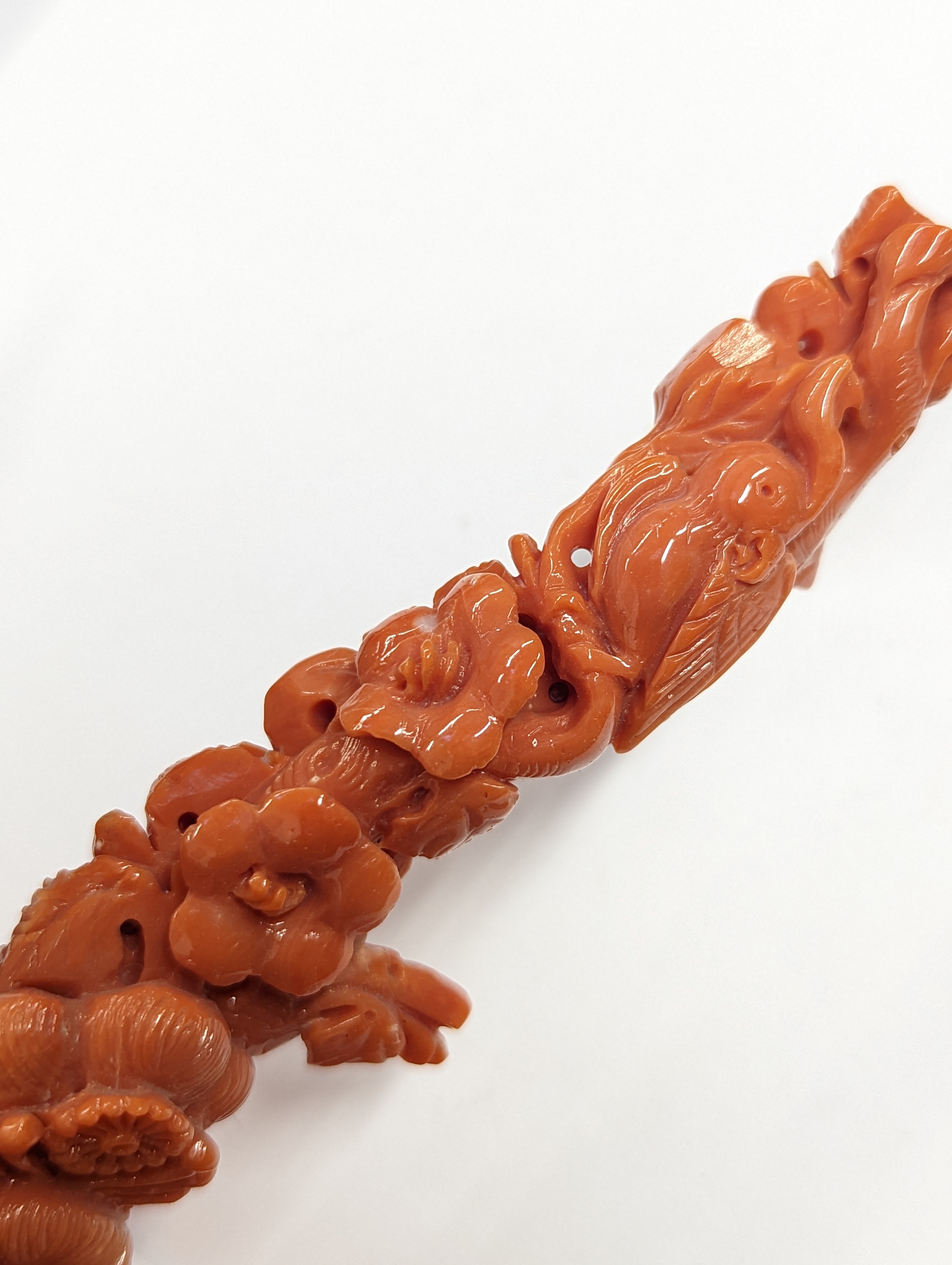 Lot 325 - λ A CHINESE CORAL CARVING OF AN IMMORTAL