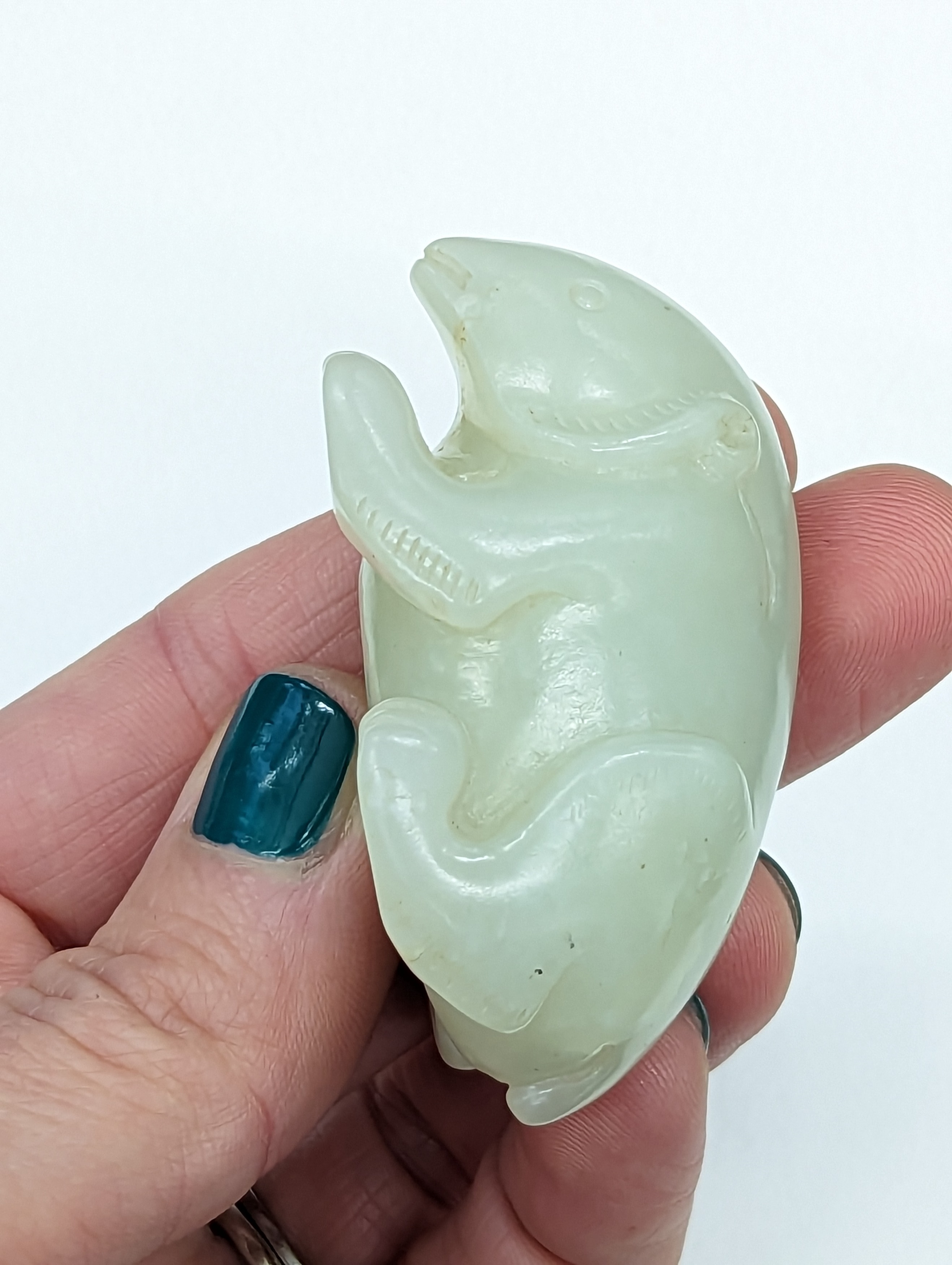 Lot 515 - A CHINESE PALE-CELADON JADE 'BEAR' CARVING