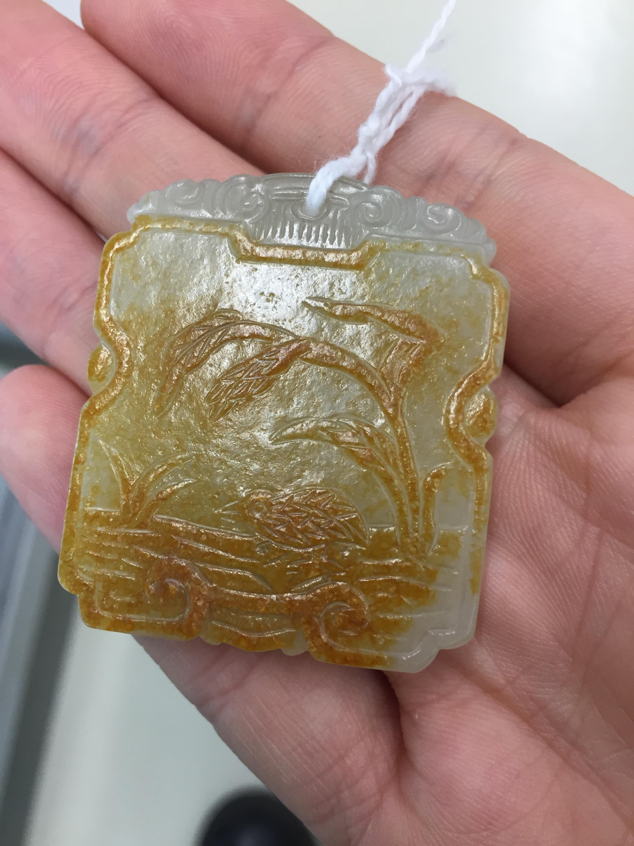 Lot 518 - A CHINESE PALE-CELADON AND RUSSET JADE