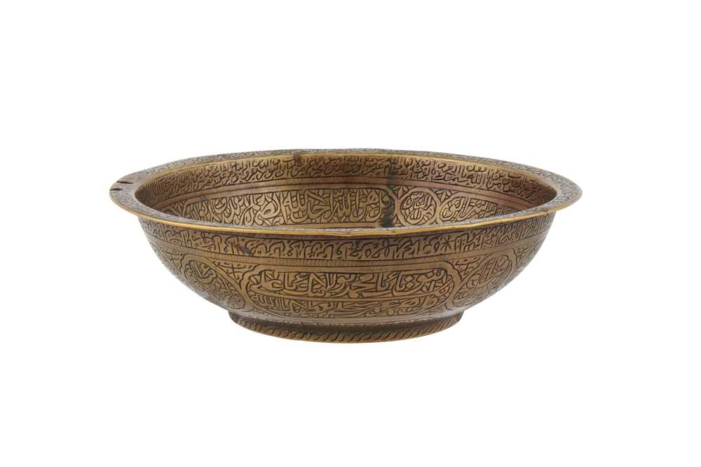 Lot 166 - A QAJAR ENGRAVED BRASS 'MAGIC' BOWL
