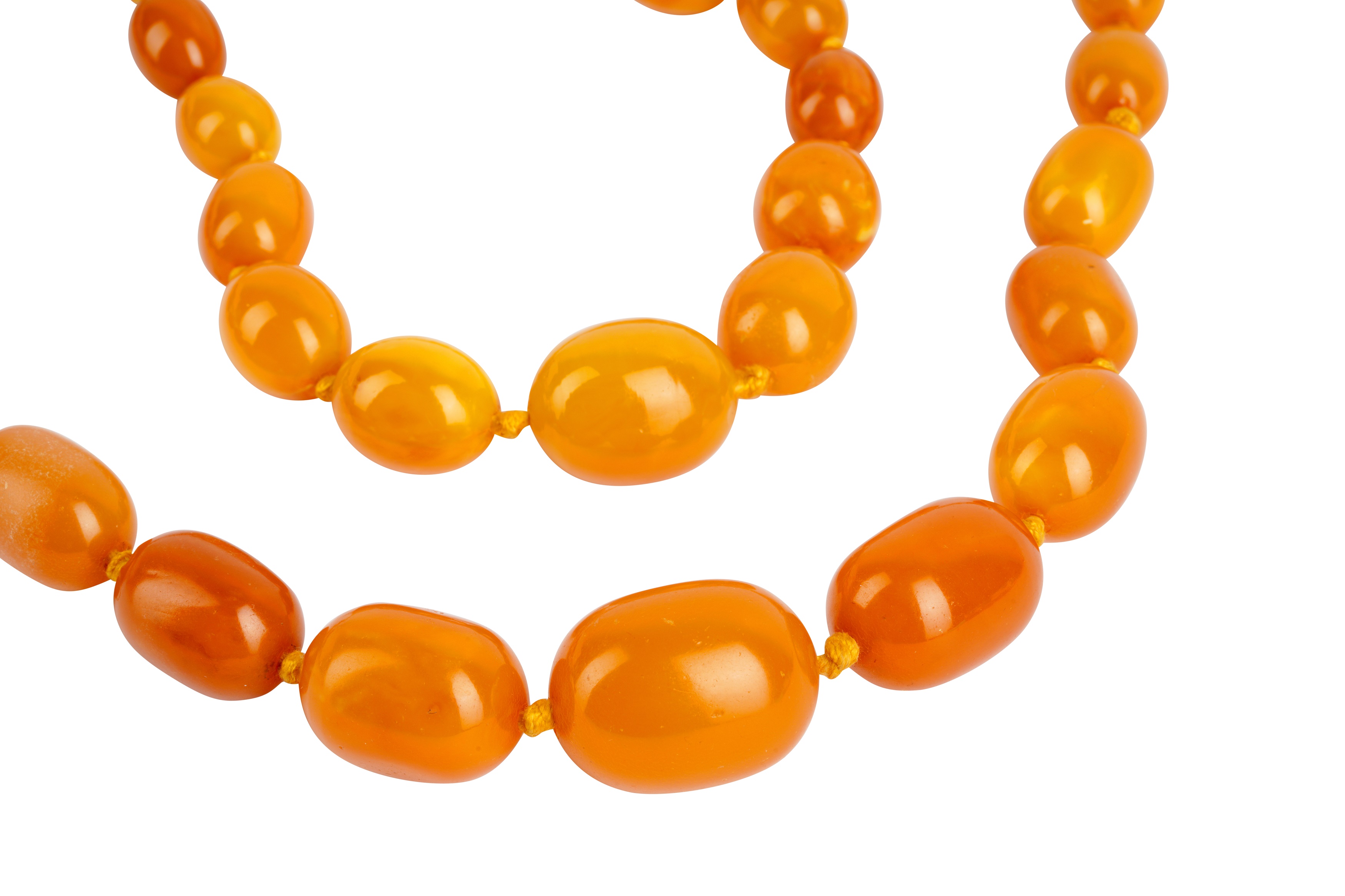 Lot 61 - TWO AMBER BEAD NECKLACES