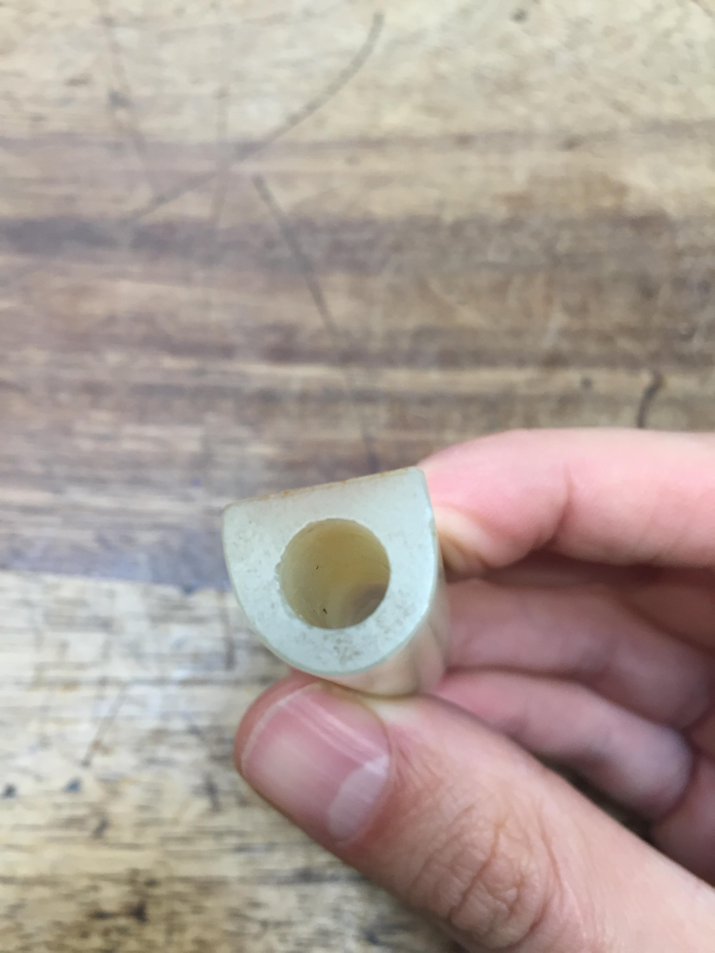 Lot 731 - A CHINESE CELADON AND RUSSET JADE PENDANT