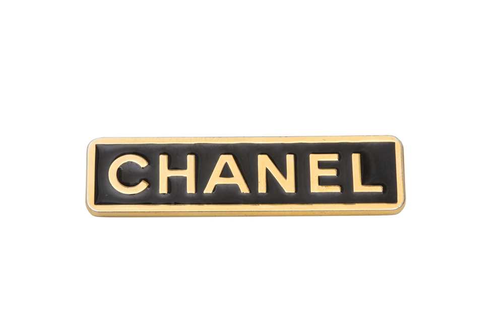 Lot 412 - Chanel Black 'CHANEL' Plaque Brooch