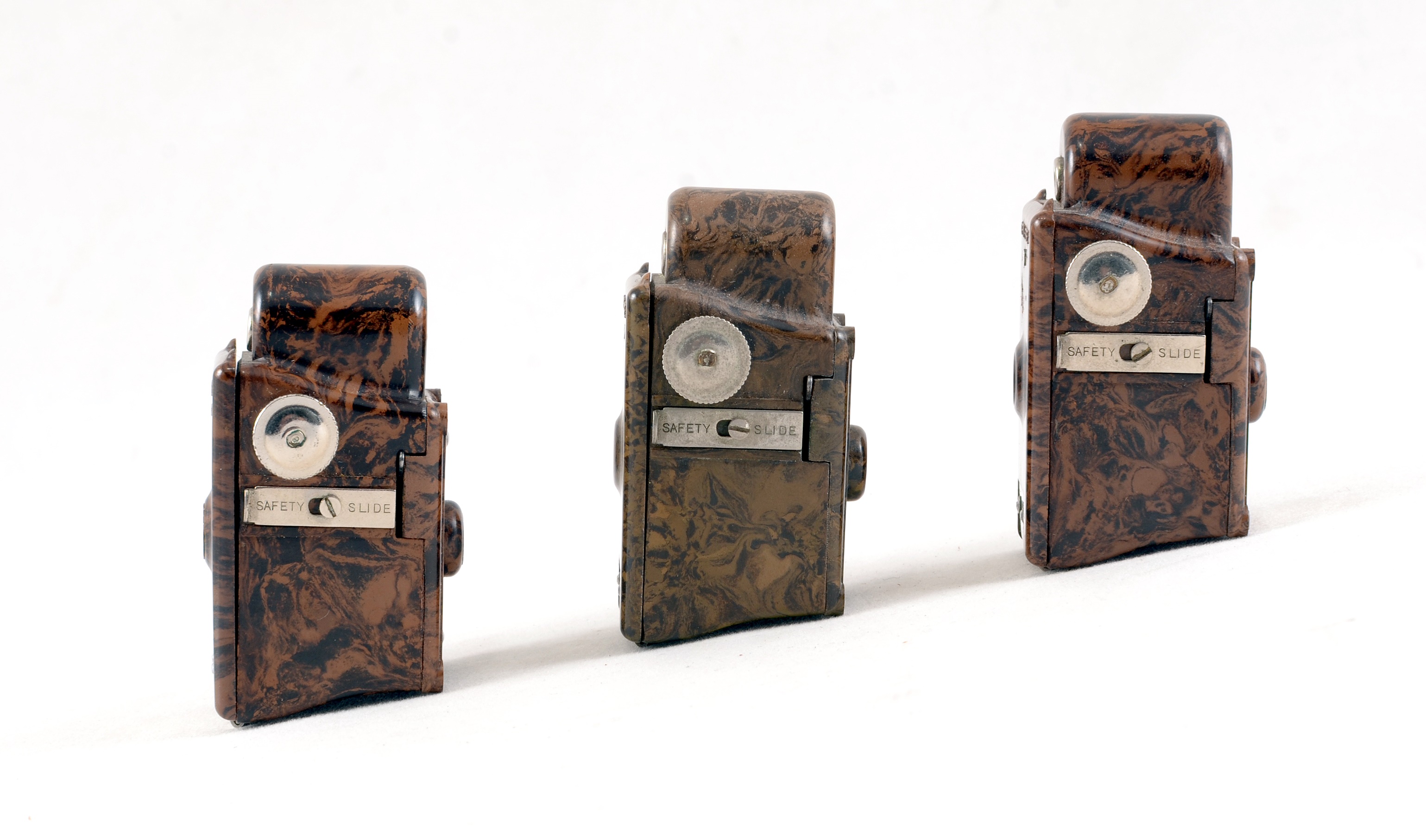 Lot 213 - Three Coronet Midget Sub-Miniature Cameras.