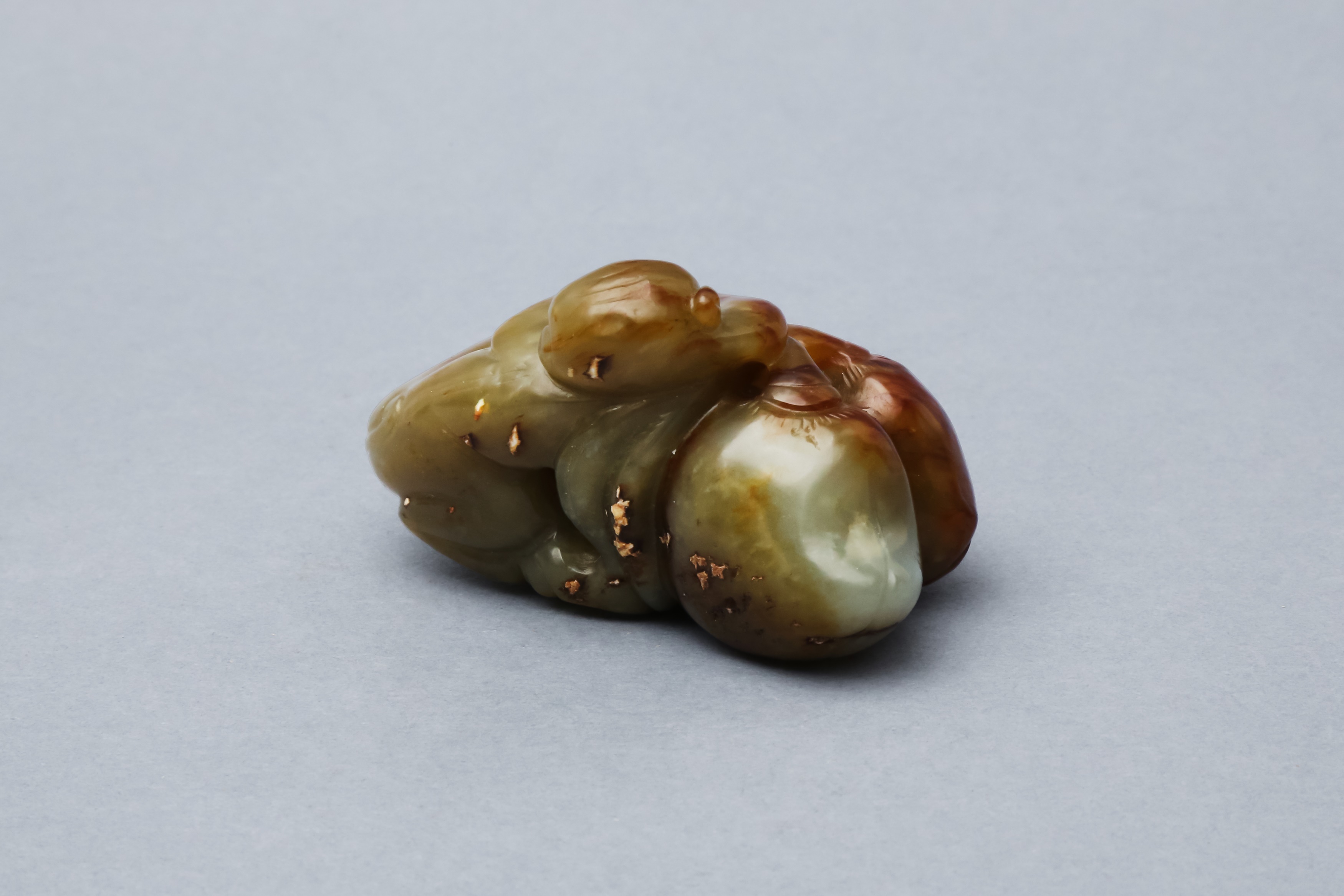 Lot 513 - A CHINESE RUSSET JADE 'MONKEY AND PEACH'