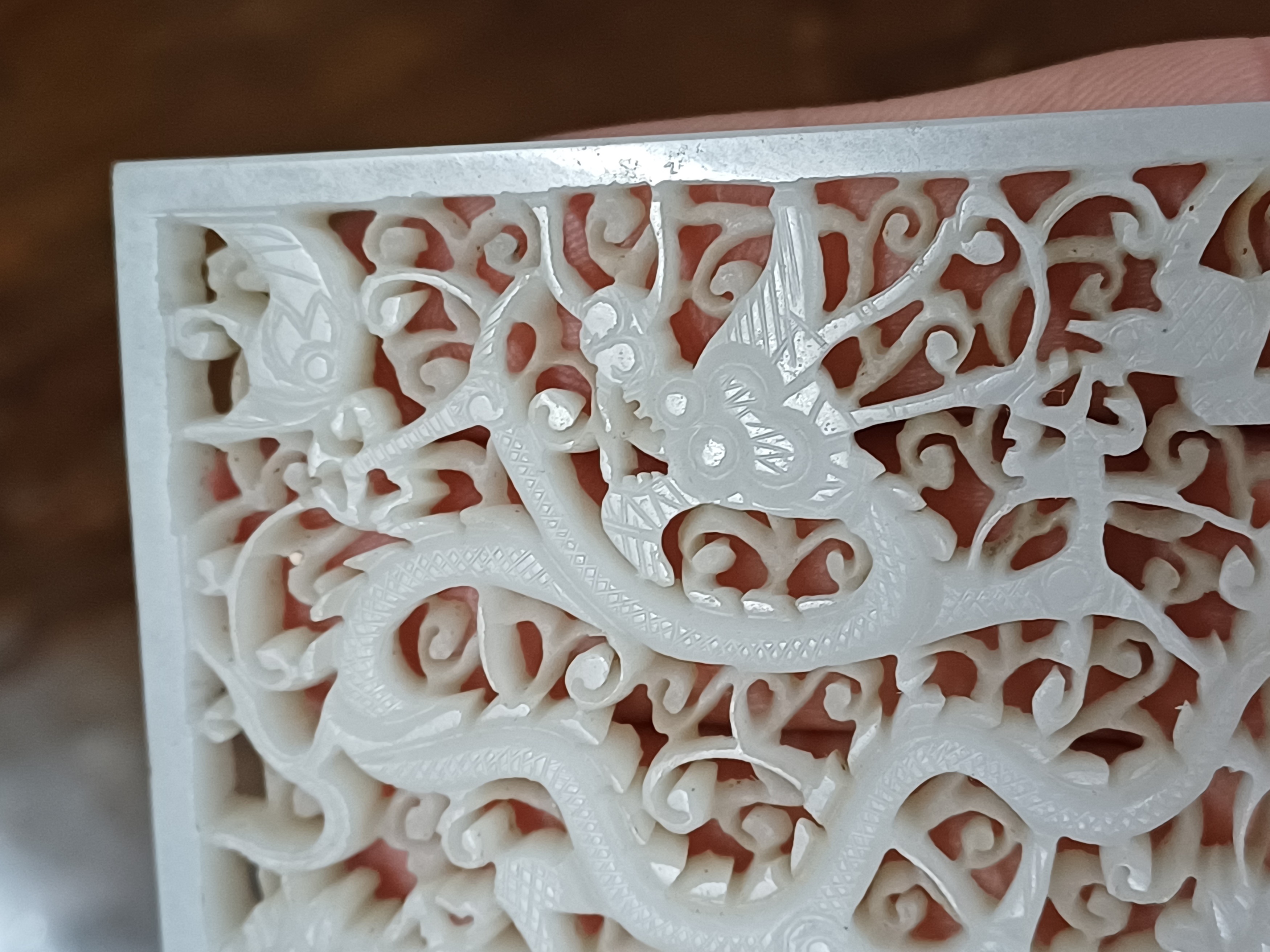 Lot 120 - A CHINESE WHITE JADE RETICULATED 'DRAGON'