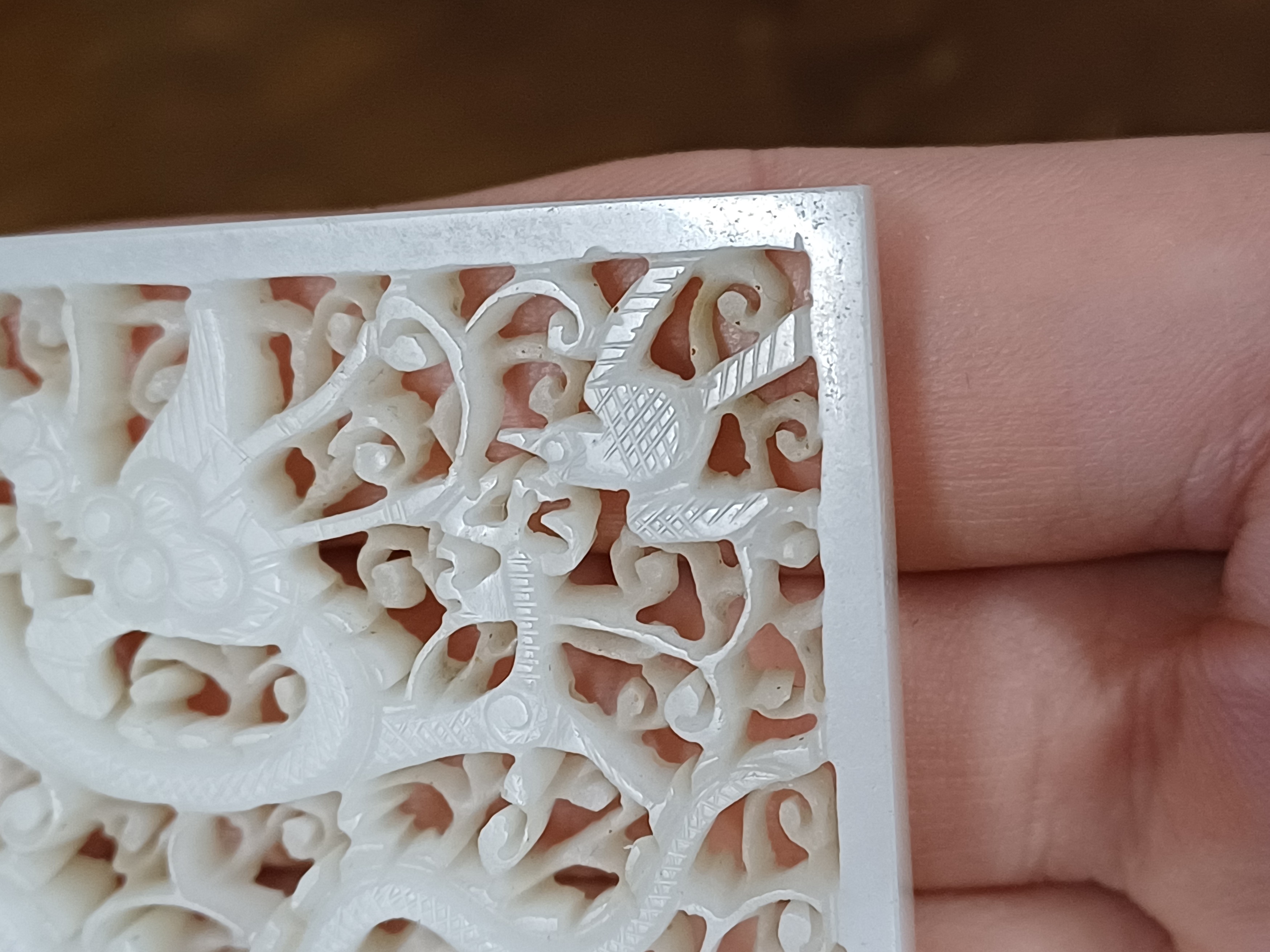 Lot 120 - A CHINESE WHITE JADE RETICULATED 'DRAGON'
