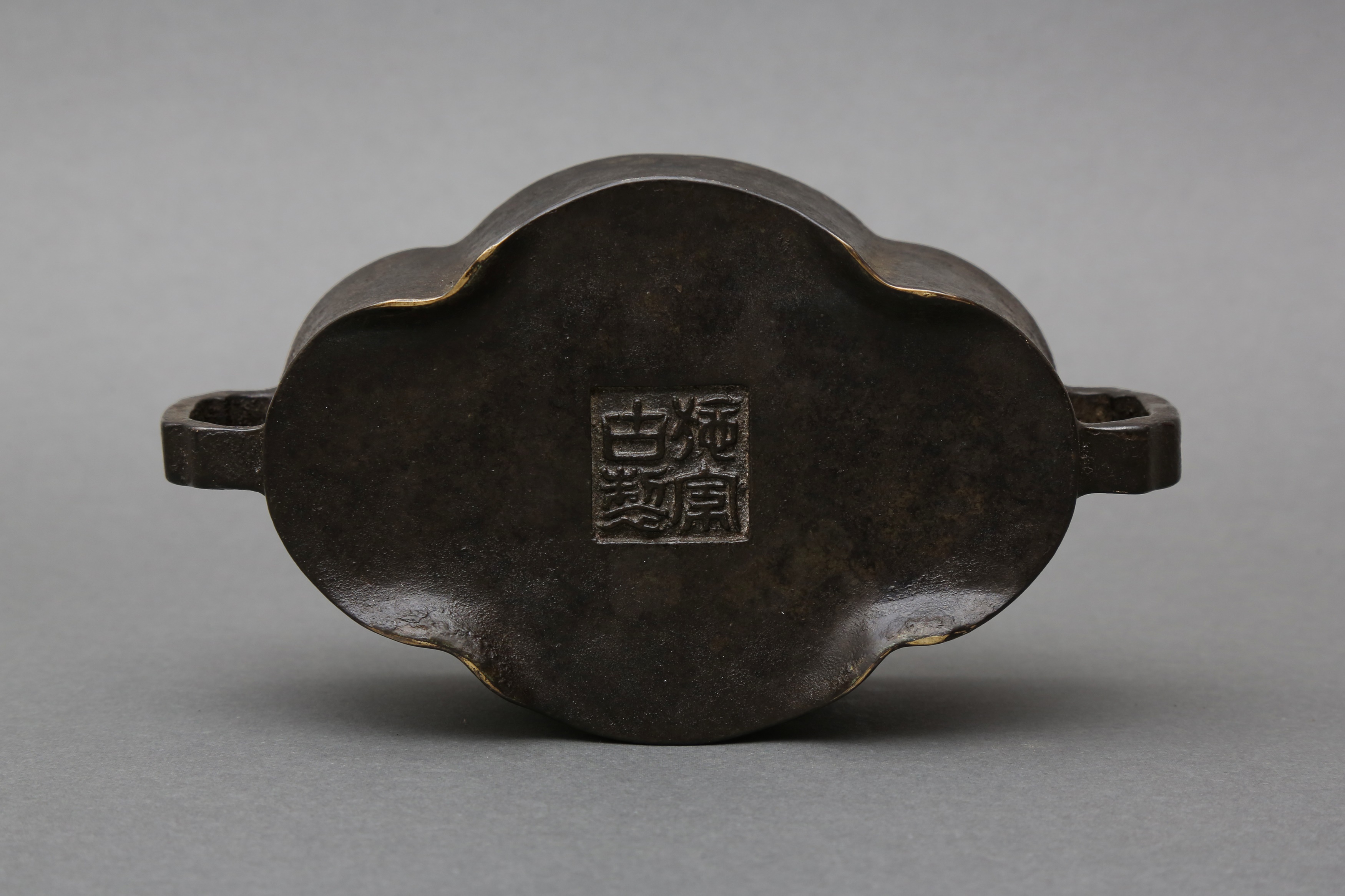 Lot 560 - A CHINESE BRONZE LOBED TWO-HANDLED CENSER,
