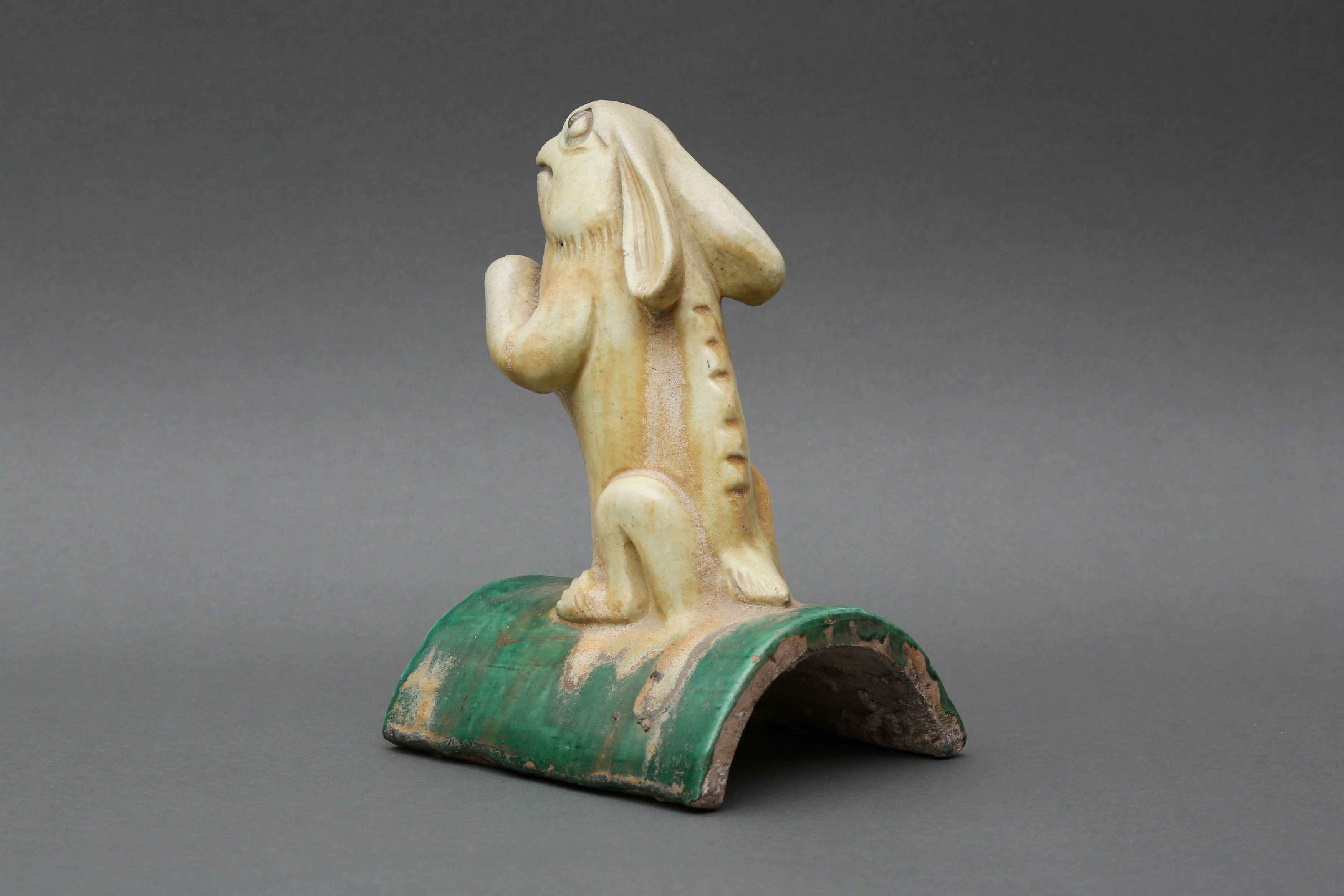 Lot 18 - A CHINESE SANCAI-GLAZED 'RABBIT' ROOF TILE