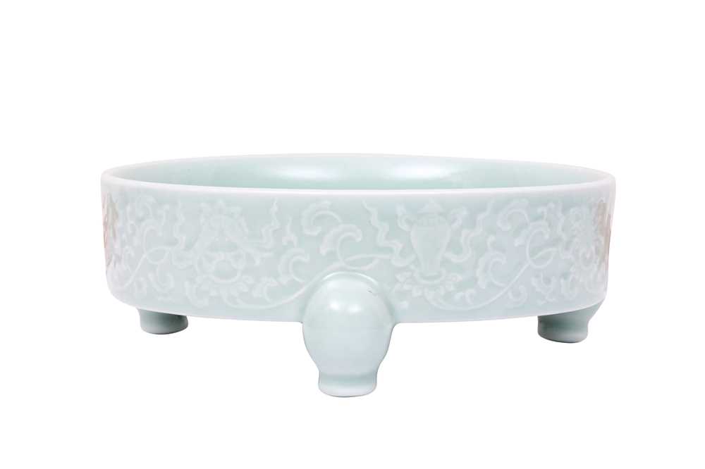 Lot 616 - A CHINESE MONOCHROME CELADON-GLAZED MOULDED