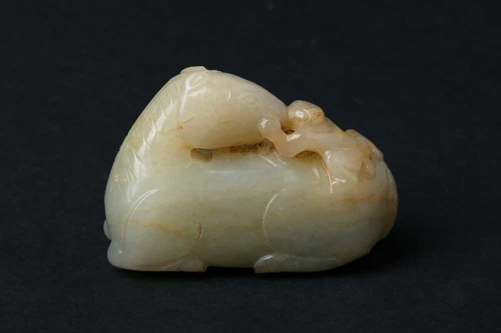 Lot 74 - A CHINESE RUSSET JADE 'RECUMBENT HORSE AND