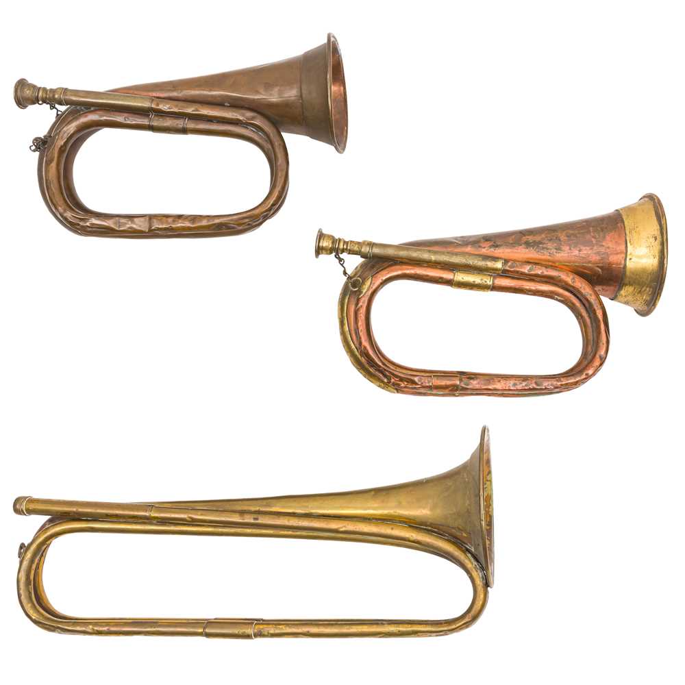Lot 202 - A group of three WWI period military bugles,