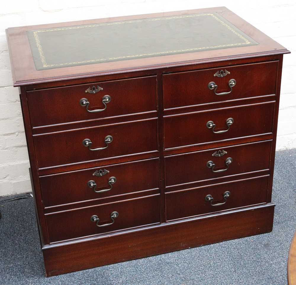 Lot 823 - A leather top locking double filing cabinet,