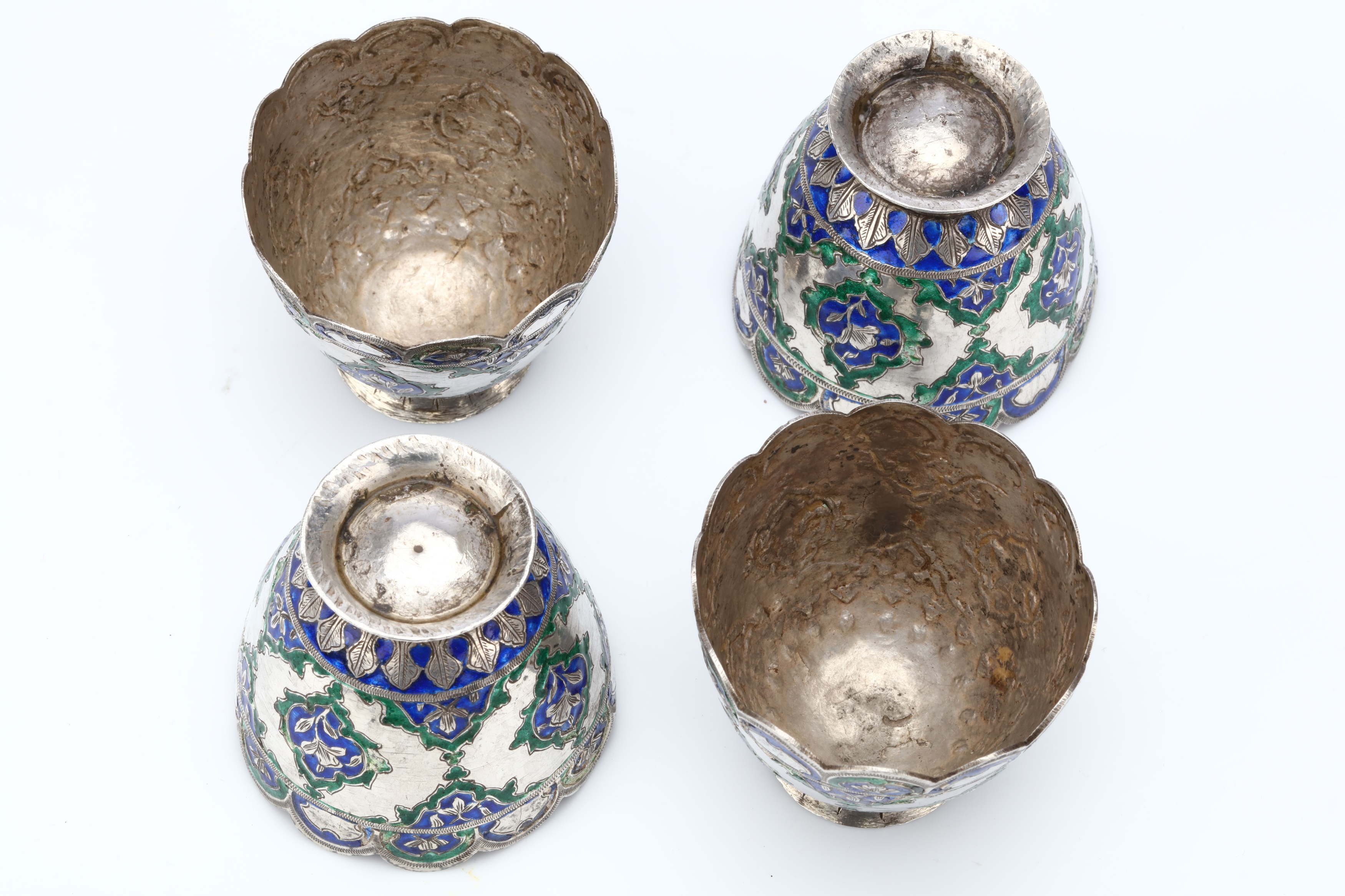 Lot 100 - FOUR PERSIAN QAJAR SILVER CUPS, with blue