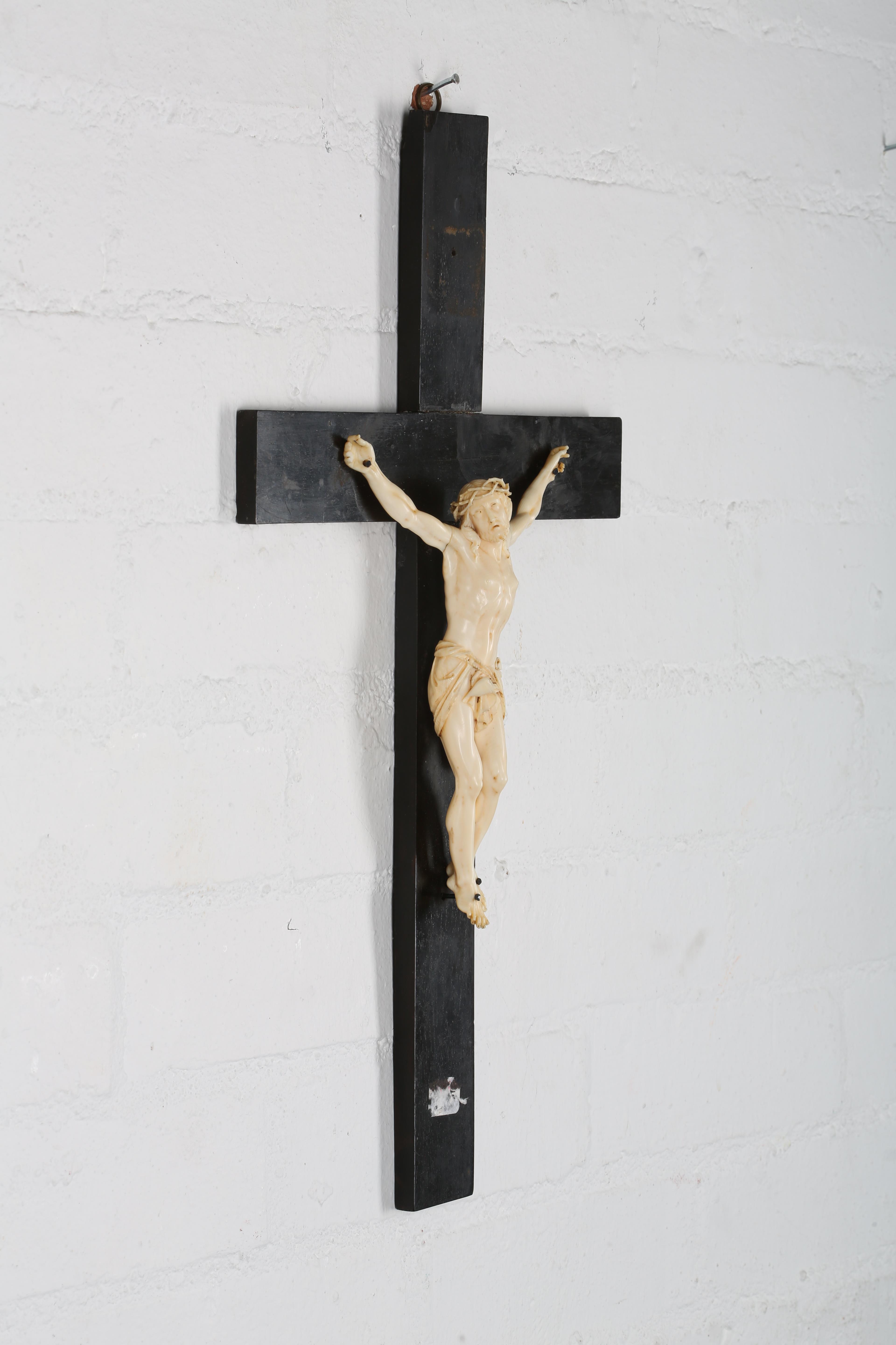 Lot 490 - A carved ivory crucifix, 19th Century, the