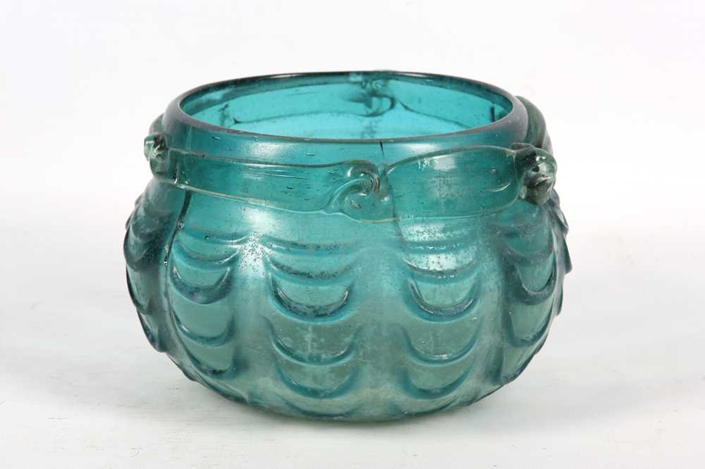 Lot 1 - AN EARLY ABBASID DEEP GREEN HOT-WORKED GLASS