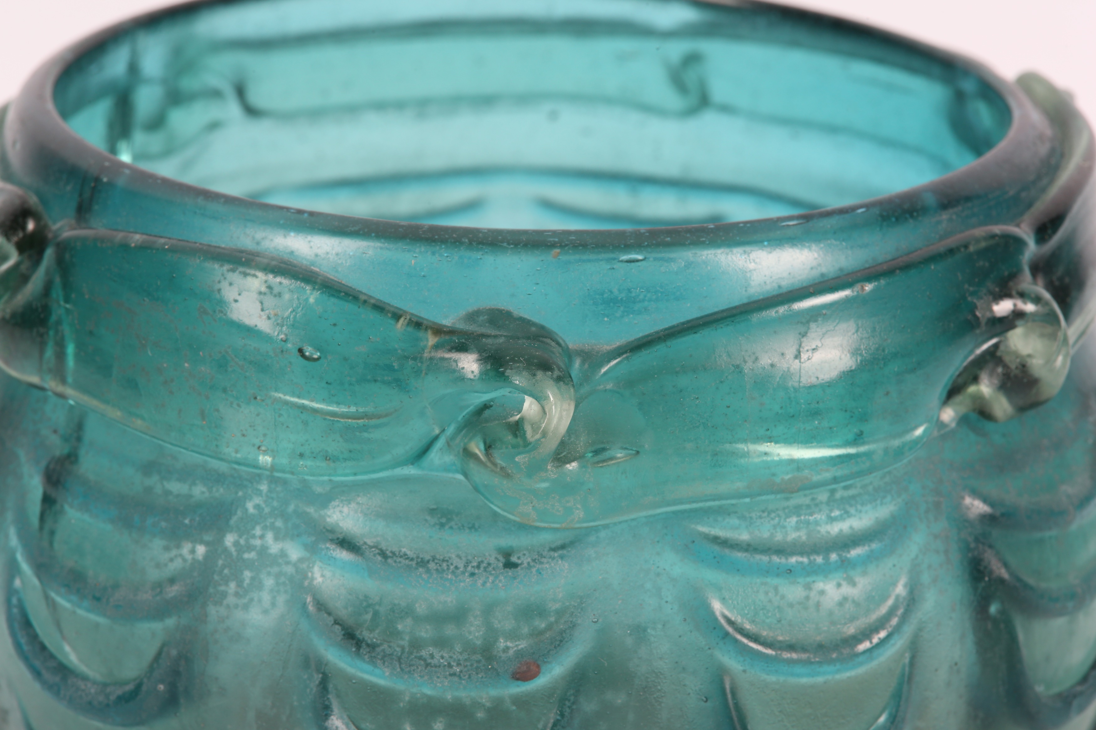 Lot 1 - AN EARLY ABBASID DEEP GREEN HOT-WORKED GLASS