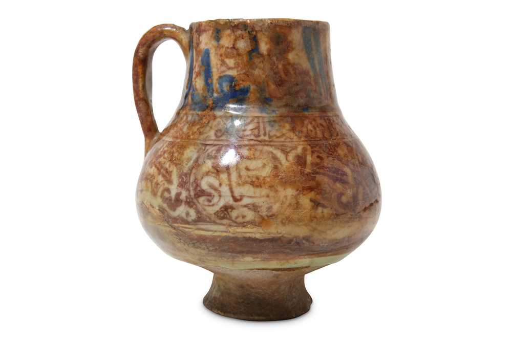 Lot 20 - A RAQQA COPPER-LUSTRE POTTERY JUG Syria, 13th