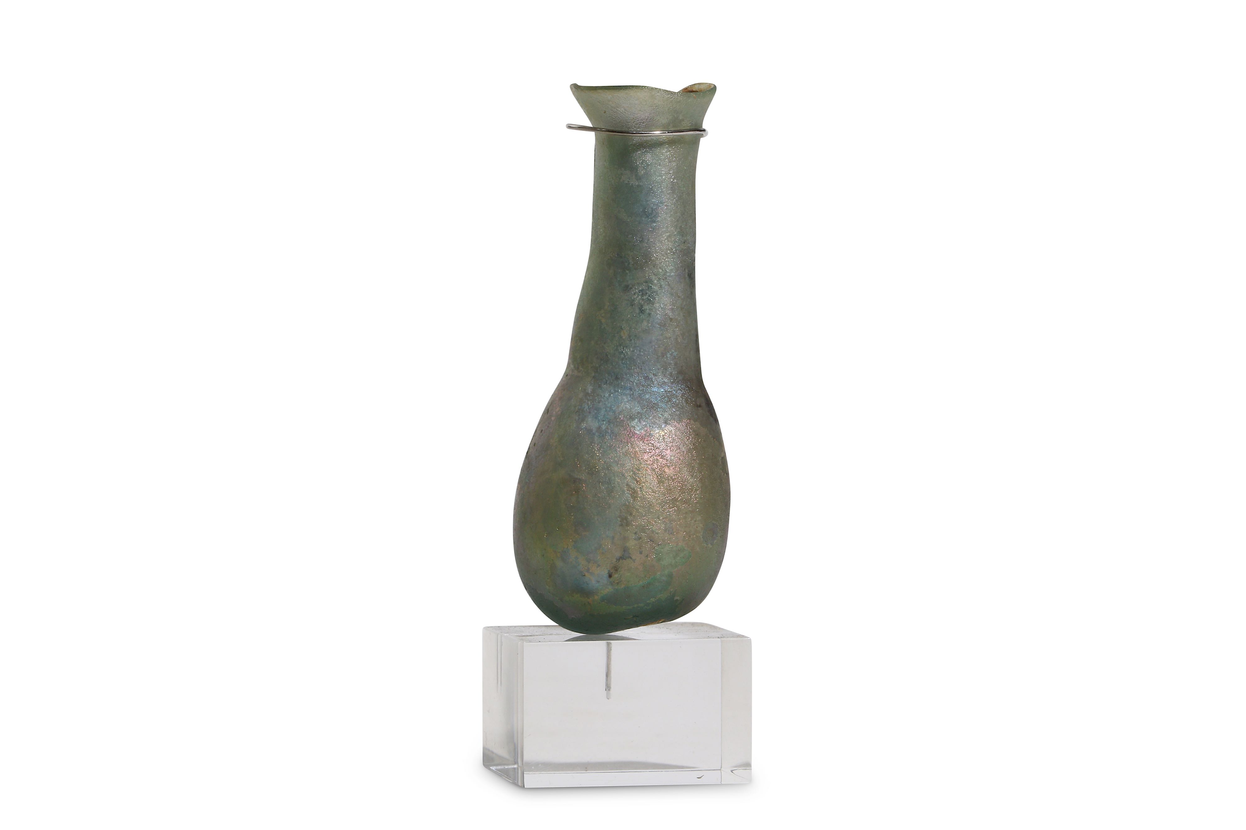 Lot 141 - A ROMAN GREEN GLASS UNGUENTARIUM Circa 3rd
