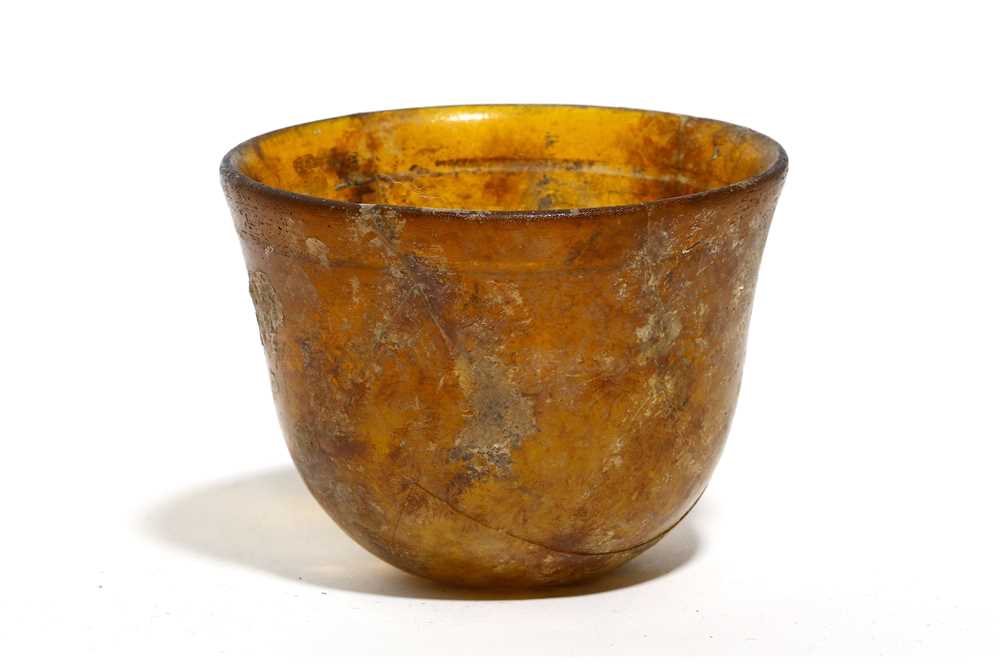 Lot 161 - A ROMAN AMBER GLASS BEAKER Circa 1st - 2nd